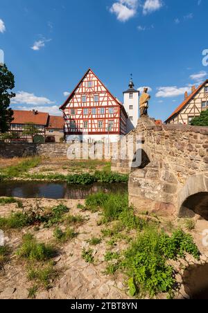 The Johannisbrücke bridge over the Streu river and the town hall in ...