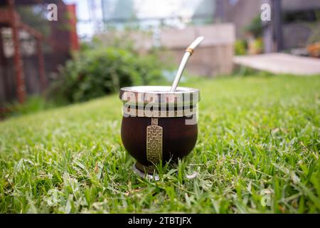 mate filled with yerba mate, next to a red thermos Stock Photo - Alamy