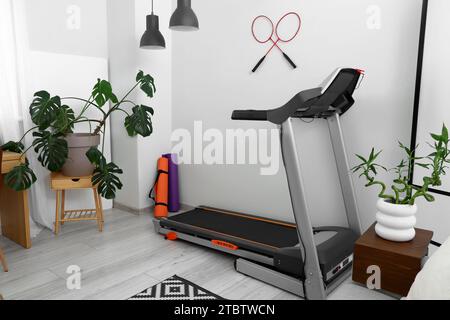 Modern treadmill in living room interior Stock Photo - Alamy