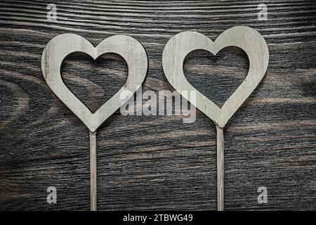 White wooden Valentine hearts with sticks on wood board celebrations ...