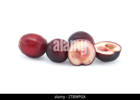 Half cut cranberry berry and fresh cranberries in wooden spoon isolated ...
