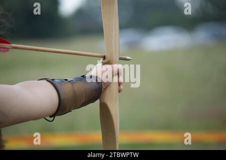 Medieval archer hand close up holding wooden bow and arrow Stock Photo ...