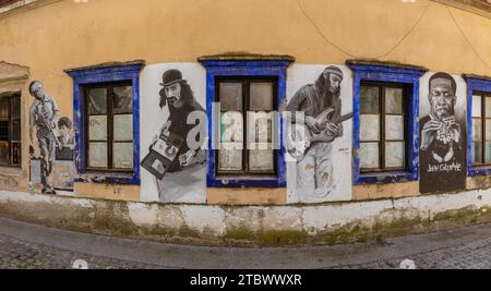 A picture of a mural in Kranj depicting jazz music legends, on an alley ...