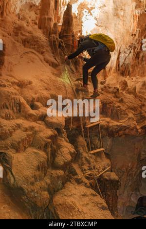 Young woman spelunking in a cave. Concept of extreme female sport Stock ...