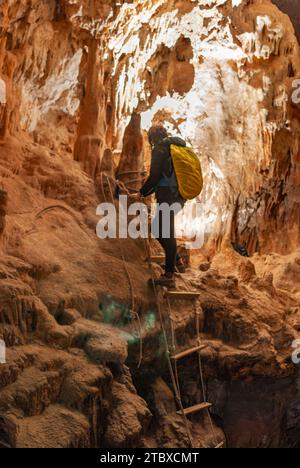 Young woman spelunking in a cave. Concept of extreme female sport Stock ...