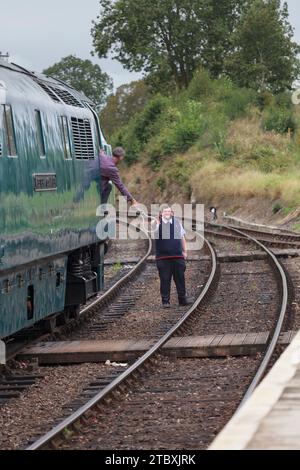 Diesel locomotive driver and signaller exchanging single line tokens at ...