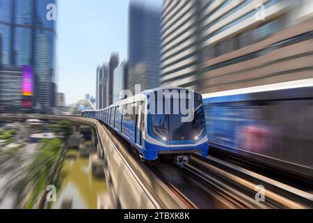 Modern high speed train over ground on a bridge on stilts among ...