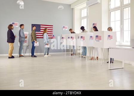 Voters stand in line at a polling station during general elections in ...