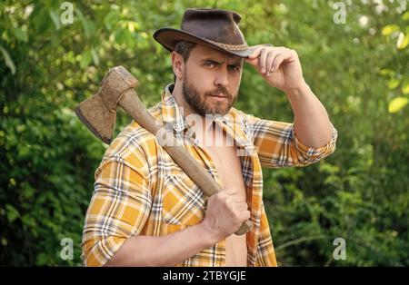 image of cowboy with axe. cowboy with axe. cowboy with axe wearing ...