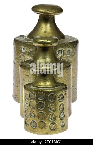vintage brass weights with several calibration hallmarks isolated on ...