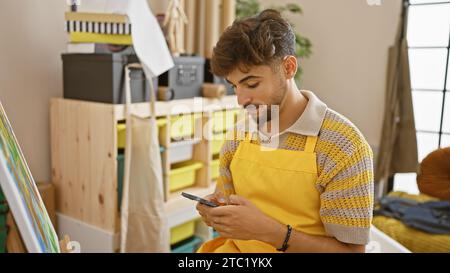 Arab man with beard painter sitting at art studio holding palette ...