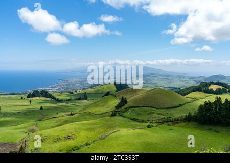 Azores landscape: expansive green fields leading to small mountains ...