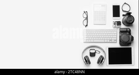 Different modern devices with eyeglasses and calculator on white ...