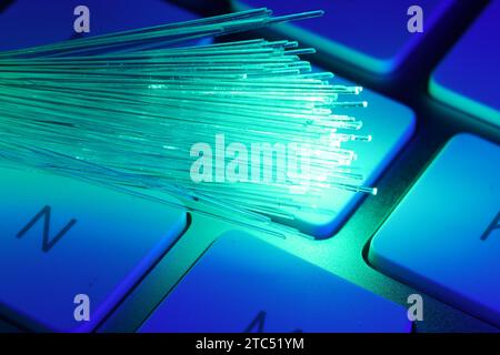 Optical fiber strands transmitting green light on computer keyboard ...