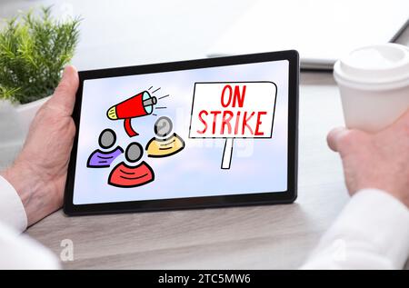 Tablet screen displaying a strike concept Stock Photo - Alamy