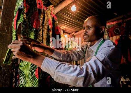 Richard Onyango (R) a tailor at Afrowema and Tatiana Teixeira checks on ...