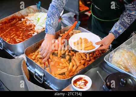 Cooking fish cakes in a shop at a street food stall in South Korea ...