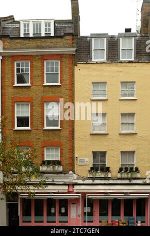 Facades of two-story residential buildings with stone paving stones on ...