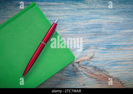 Closed green notebook biro pen on wood board education concept Stock ...