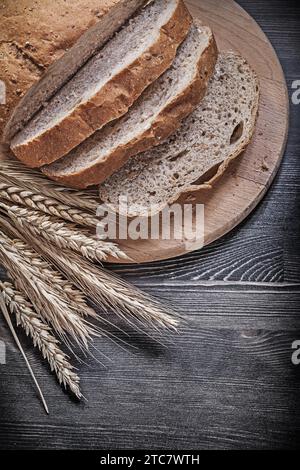 Bread carving board wheat ears red tablecloth on wooden background ...