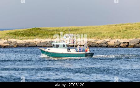 power boat heading out of montauk inlet Stock Photo - Alamy