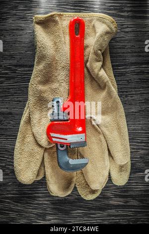 Safety gloves plumbing pipe wrench connectors water valve on wooden ...