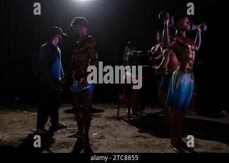 December 10, 2023: Participants gets their body painted with tanning ...