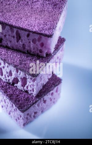New violet washing sponges on white background Stock Photo - Alamy