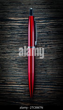 Red biro pen on vintage wooden board Stock Photo - Alamy