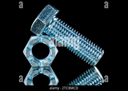 Threaded nuts on black background Stock Photo - Alamy