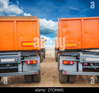 rear view through rows of tippers Stock Photo - Alamy