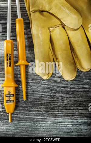 Leather safety gloves electrical tester on blue background electricity ...