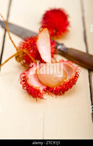 fresh tropical rambutan fruits over rustic wood table Stock Photo - Alamy