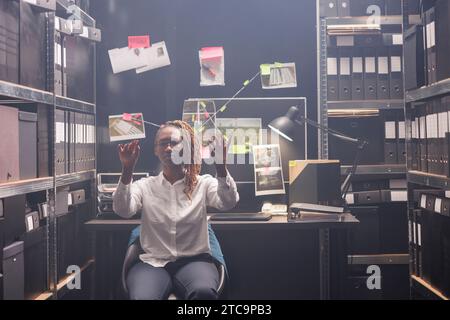 Law enforcement investigator using ar technology to analyze crime scene ...