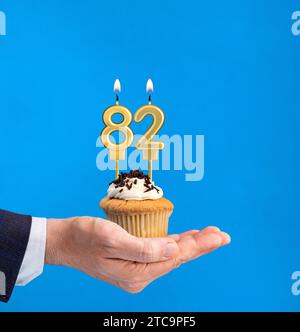 Birthday candle number 82 with cupcake - Yellow background with blue ...