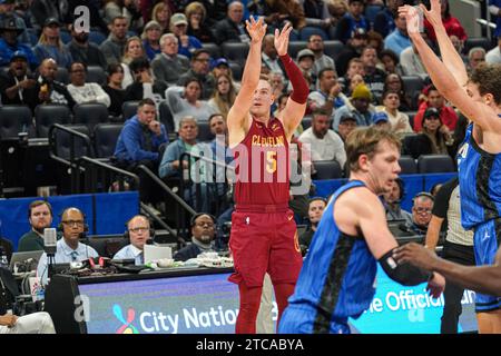 Cleveland Cavaliers guard Sam Merrill, right, looks to shoot over ...