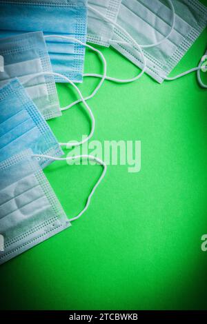 Disposable medical masks on green background medicine concept Stock ...