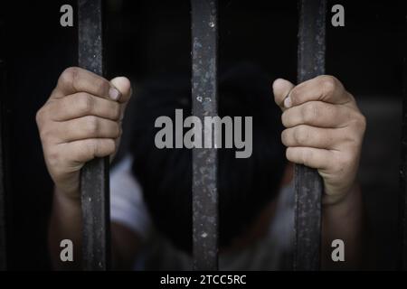 The child captured the iron cage with sadness and despair. The concept ...