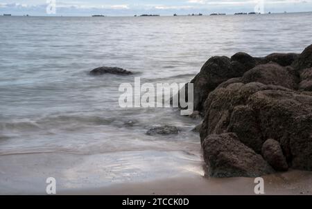 slow exposure shots of the sea waves along the rocky beach Stock Photo ...
