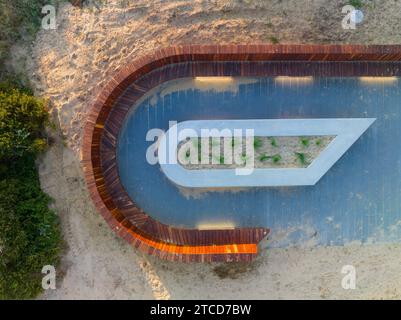 An aerial top view of a wooden bench and rocks by the scenic Hudson ...