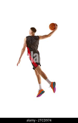 Slum dunk. Full-length image of young guy, basketball player in motion ...