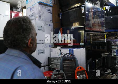 SANAA, Sanaa, Yemen. 12th Dec, 2023. Yemeni watch a televised statement ...