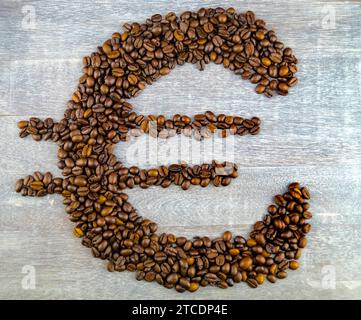 Euro sign, formed with roasted coffee beans, with Euro bills, coffee ...