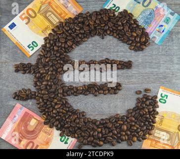 Euro sign, formed with roasted coffee beans, with Euro bills, coffee ...
