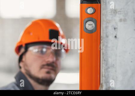 A worker in a construction helmet checks a clipboard Stock Photo - Alamy