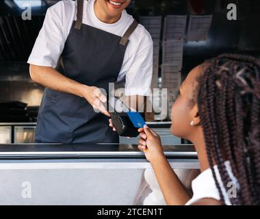 Cropped shot of female business owner typing using her laptop, standing ...