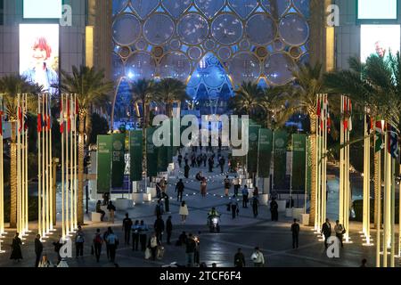 Participants walk on Al Wasl Avenue on the last day of COP28, UN ...