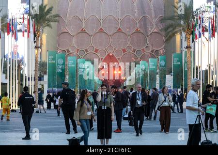 Participants walk on Al Wasl Avenue on the last day of COP28, UN ...