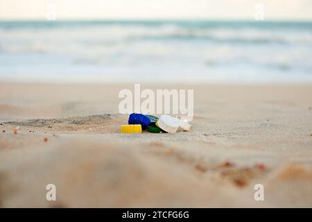 Assorted plastic bottle caps discarded on the sand at a beach in Brazil ...
