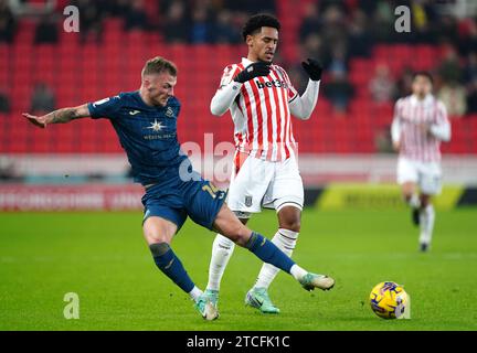 Swansea City's Josh Tymon (left) and Coventry City's Victor Torp battle ...